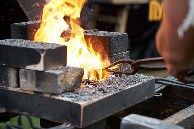 Forge, Blacksmith Forges Metal, Splinters. Blacksmith in the Forging ...