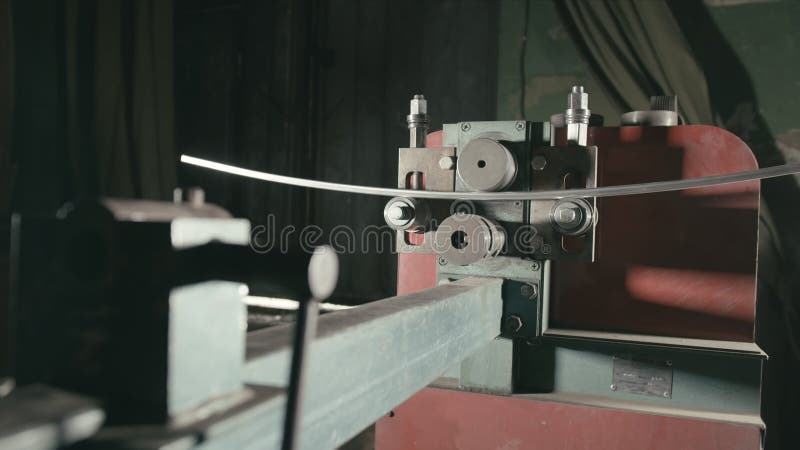 Forge Workshop on Table. Worker Bends the Metal Rod on the Wrought Iron ...