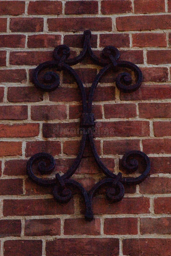 Forged Pattern on a Brick Wall, a Figure of Iron Stock Image - Image of ...