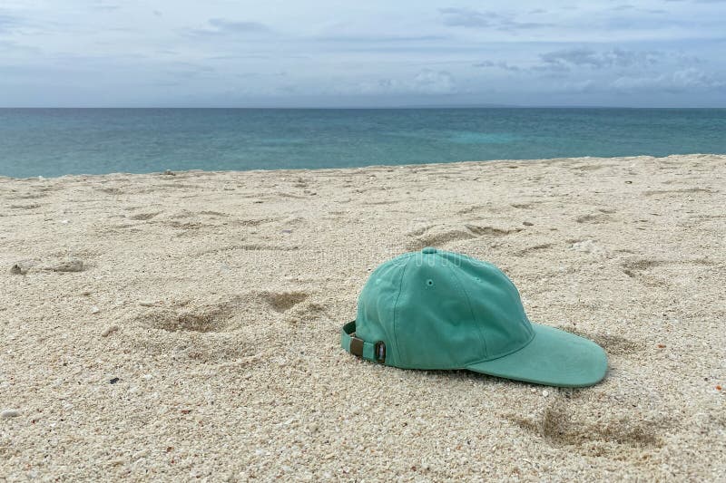 Forgotten Cap on a Sandy Beach Against the Blue Sea Stock Photo - Image ...