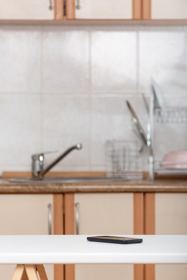 Forgotten Smartphone on Kitchen Table. Mobile Phone on the Kitchen ...