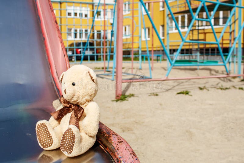 Forgotten Toy Teddy Bear in the Empty Quarantined Playground Stock ...