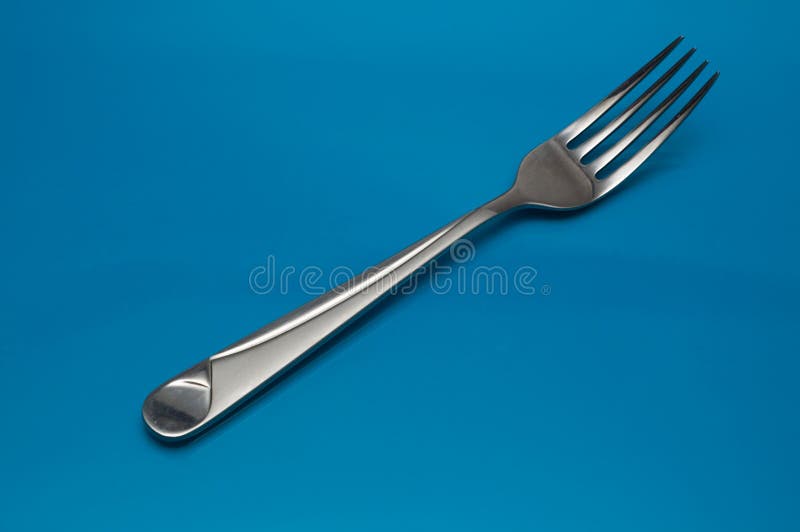 Fork on a blue background stock photo. Image of meal - 12753714