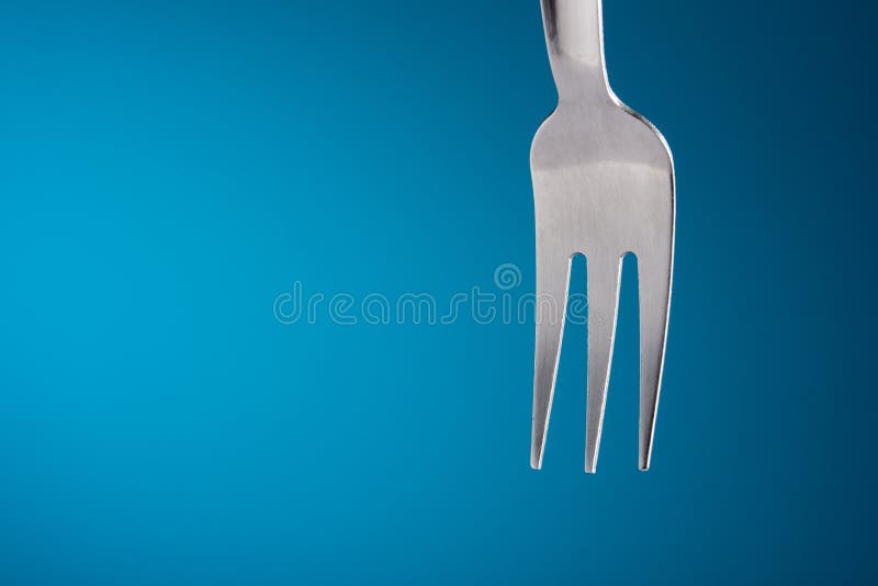 Fork in Blue Background in Studio Stock Photo - Image of element, front ...