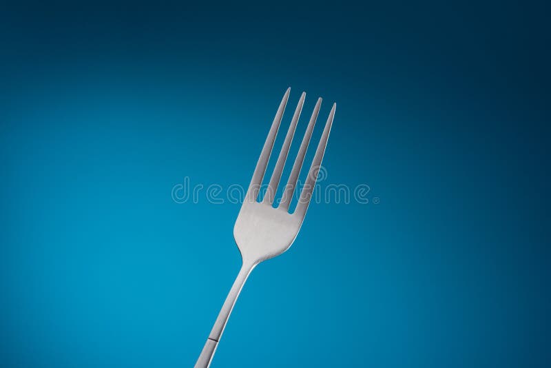Fork in Blue Background in Studio Stock Image - Image of blue, high ...