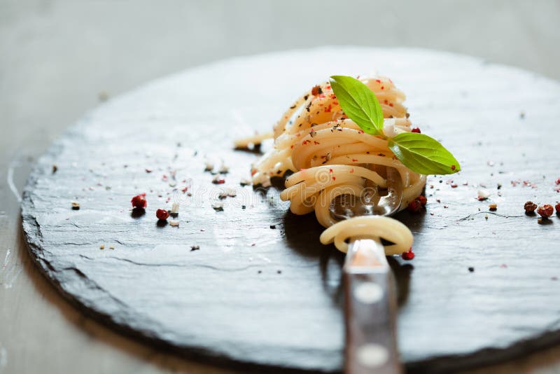 Fork with Italian Spaghetti Pasta with Basil and Cheese on Dark Slate ...