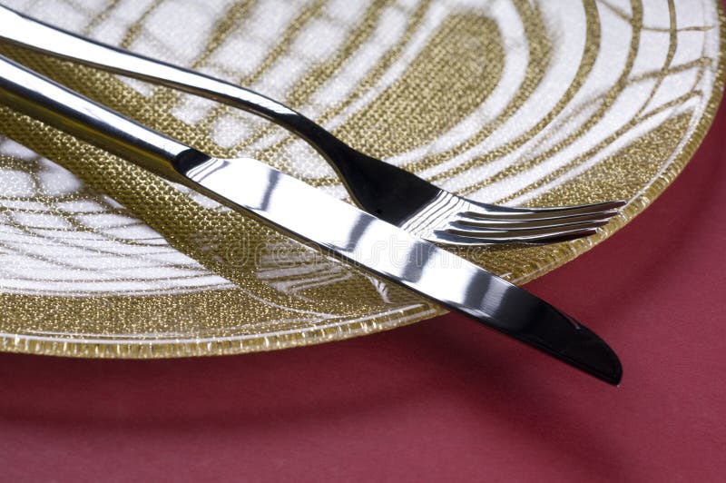 Fork and knife on a plate stock photo. Image of close - 17443002