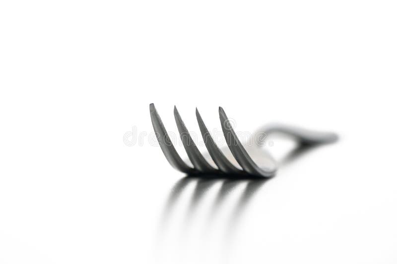 Sleek Metallic Fork Resting on a Reflective Surface, Capturing ...