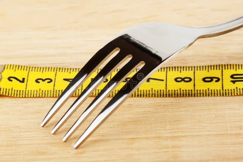 Fork with measuring tape stock photo. Image of table - 22816100
