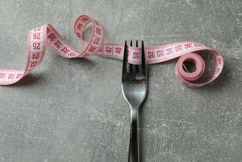 Fork with Measuring Tape on Gray Background Stock Photo - Image of ...