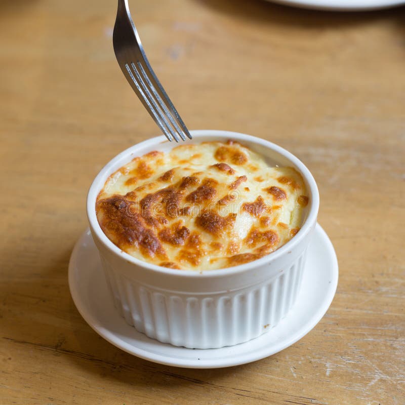 Fork is Scooping Up Cheese Mashed Potatoes in White Cup on the Wood ...