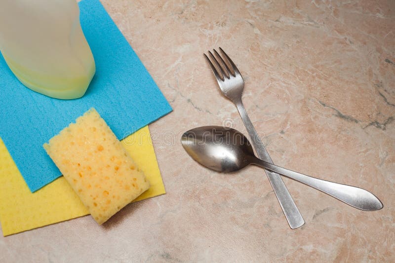 Fork, a Spoon, a Bottle of Detergent, Colored Rags and a Sponge for ...