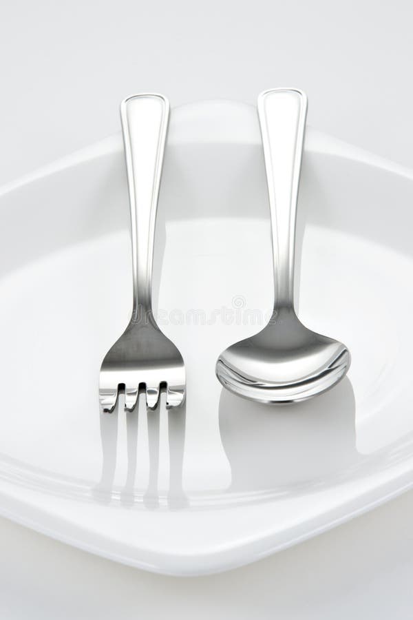 Fork & Spoon on White Dish Stock Image - Image of cafe, cook: 22281851