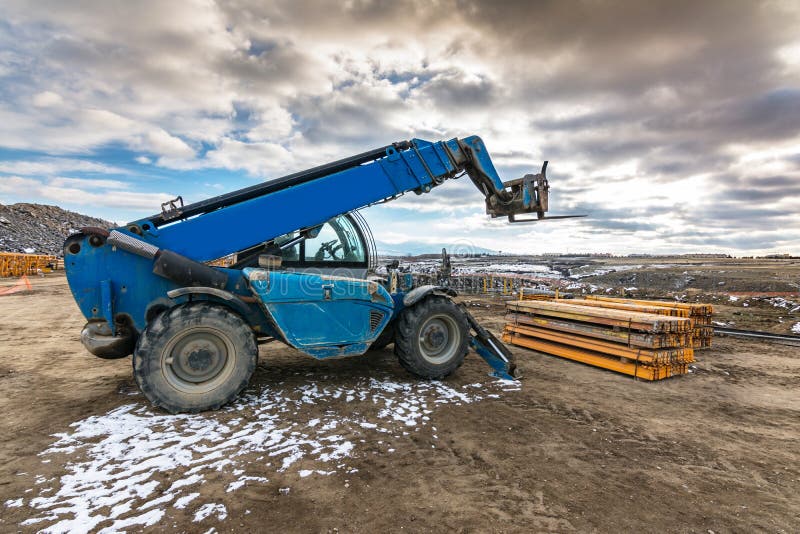 Forklift on a Construction Site, Preparing To Raise Construction Parts ...