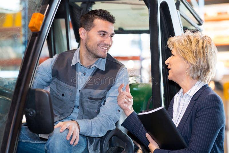 Forklift Driver and Manager Smiling in Large Warehouse Stock Photo ...