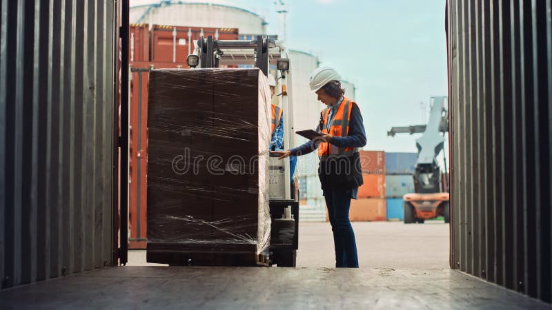Forklift Driver Loading a Shipping Cargo Container with a Full Pallet ...