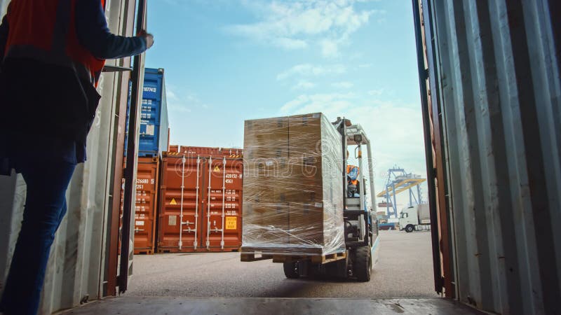 Forklift Driver Loading a Shipping Cargo Container with a Full Pallet ...
