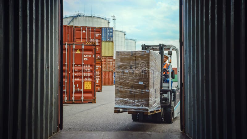 Forklift Driver Loading a Shipping Cargo Container with a Full Pallet ...