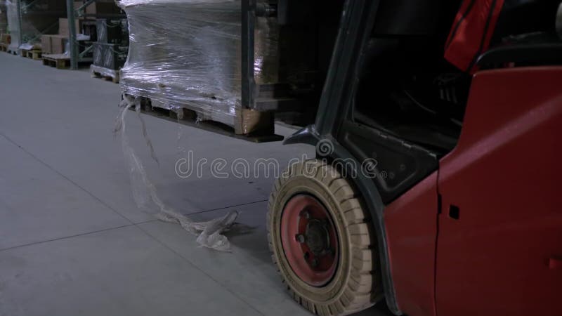 A Forklift Driver Picking Up a Palette of Boxes in a Large Warehouse ...