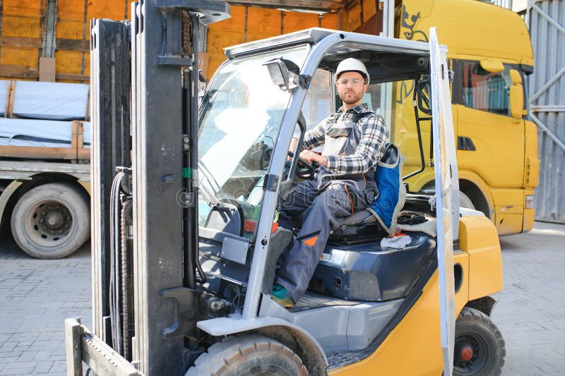 Forklift Driver in Protective Vest and Forklift Standing at Warehouse ...