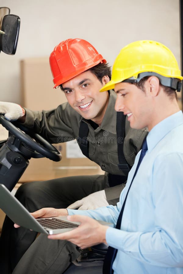 Forklift Driver with Supervisor Using Laptop Stock Photo - Image of ...