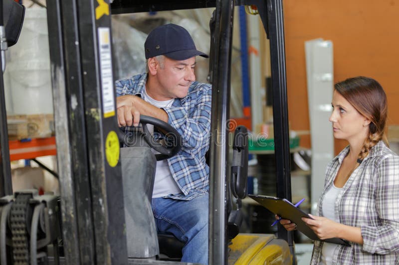 Forklift Driver Talking with Manager in Large Warehouse Stock Photo ...