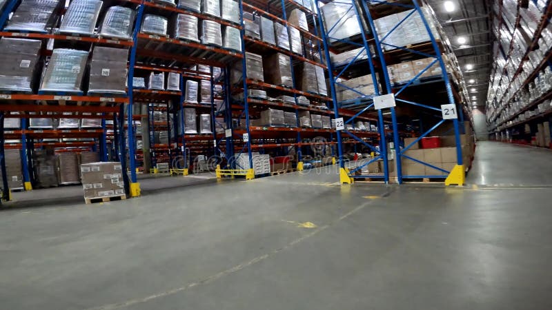 Moving through a Modern Warehouse. a Forklift is Driving through a ...