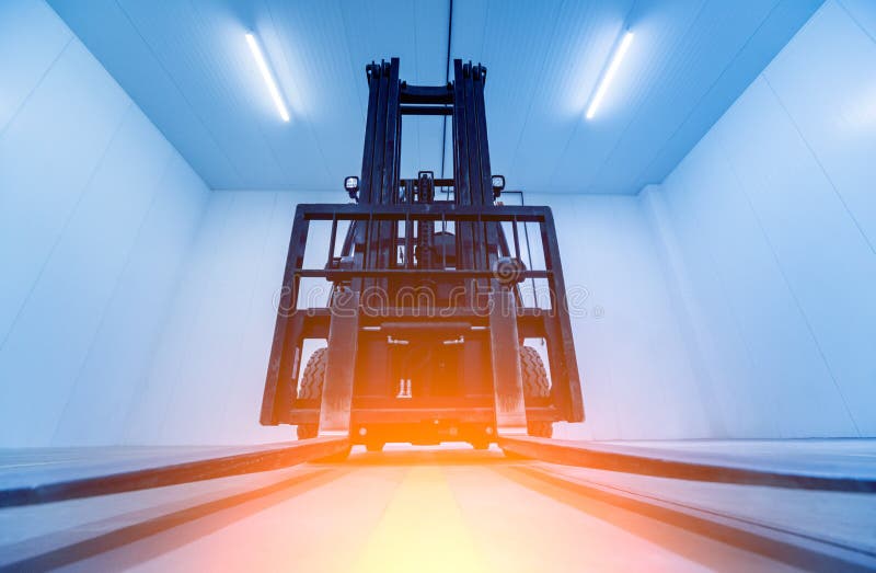 Forklift in a Large Industrial Freezer Warehouse. Empty Warehouse Stock ...