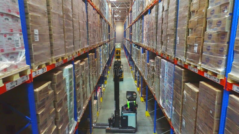 Warehouse Work. Modern Loaders in a Large Warehouse. Special Equipment ...
