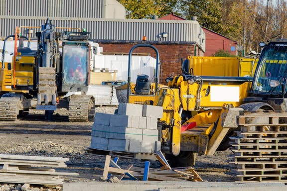 Forklift Lifting and Moving Bricks on a Pallet on Construction Site ...