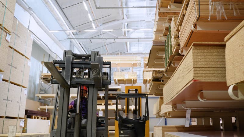 Forklift Loader in Storage Lumber Warehouse. Distribution Products ...