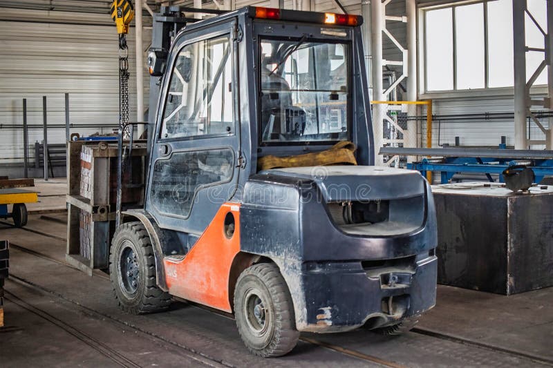 Forklift Moving a Heavy Load through an Industrial Workshop during ...
