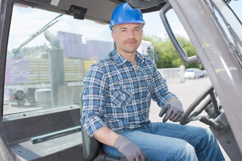 Forklift operator posing stock image. Image of driver - 308543075