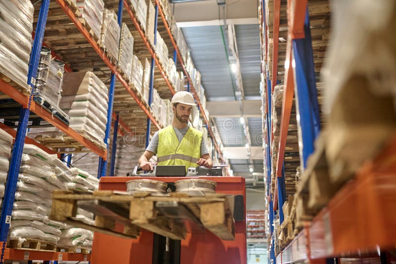 Serious Worker Handling Merchandise in the Storage Area Stock Photo ...