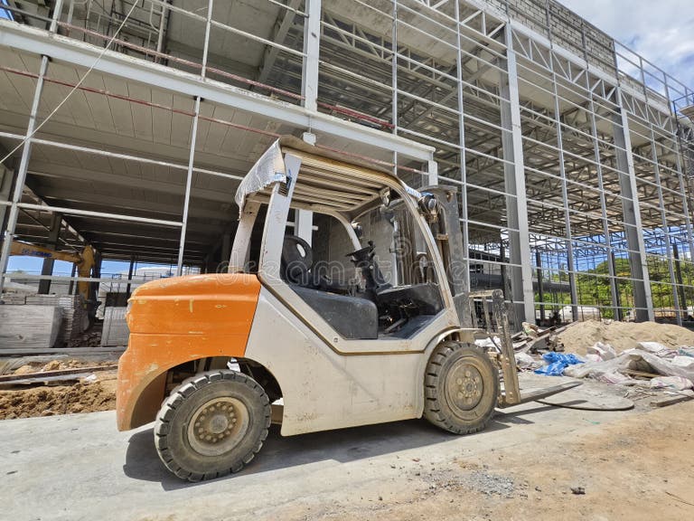 A Forklift is Parked in Front of a Building Under Construction Stock ...