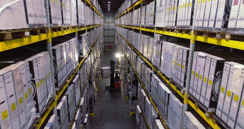 The Forklift Puts the Goods on the Shelves of the Warehouse. Warehouse ...