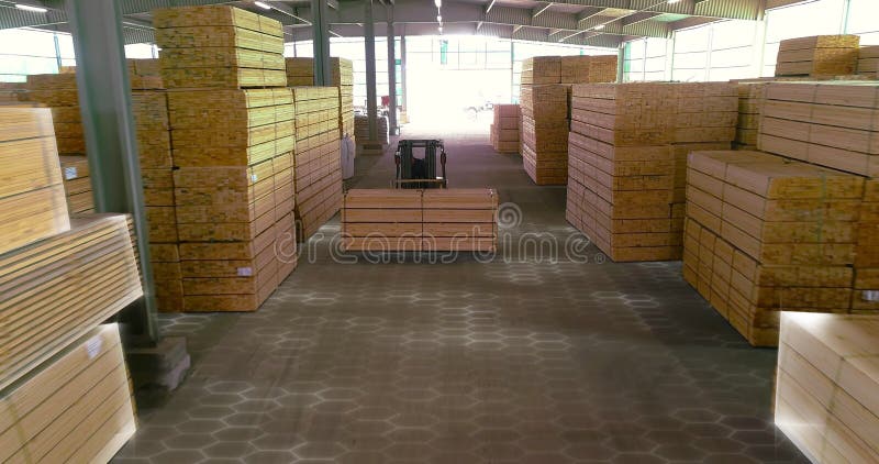 A Forklift Rides Over a Lumber Pile. Modern Technologies at the Lumber ...