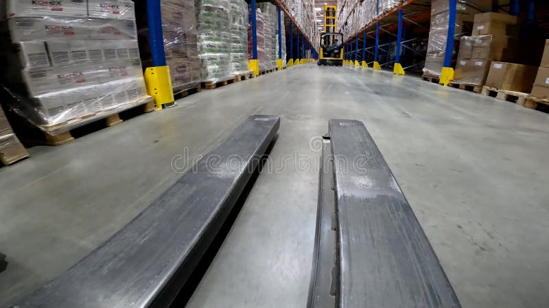 The Forklift Rides through the Warehouse Close-up. Forklift Work in a ...