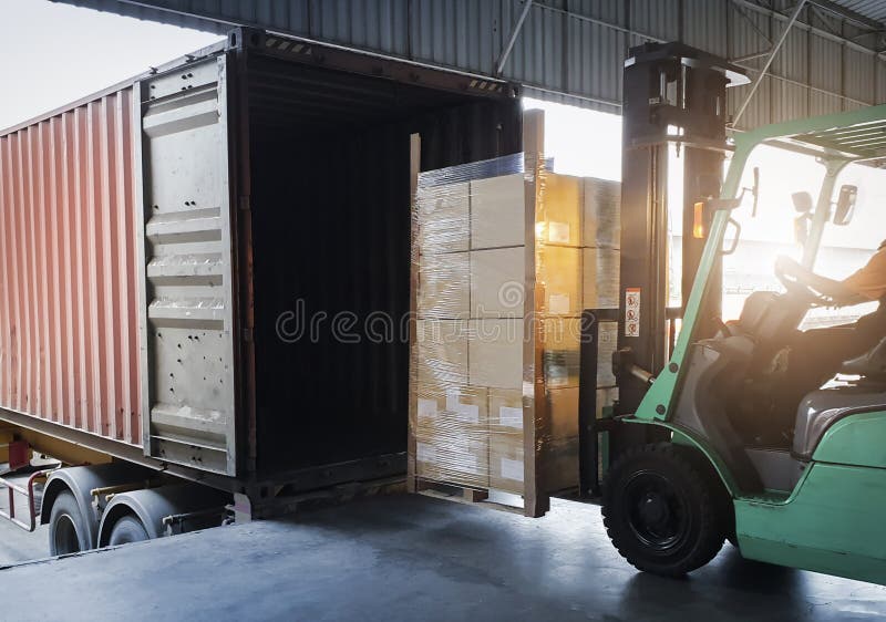 Forklift Tractor Loading Packaging Boxes into Container Trucks ...