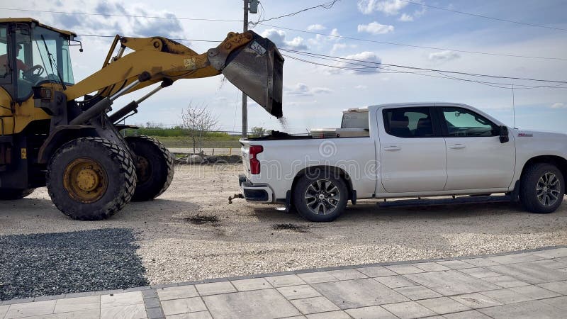 A Forklift Unloads Crushed Stone into a Vehicle. Stock Photo - Image of ...