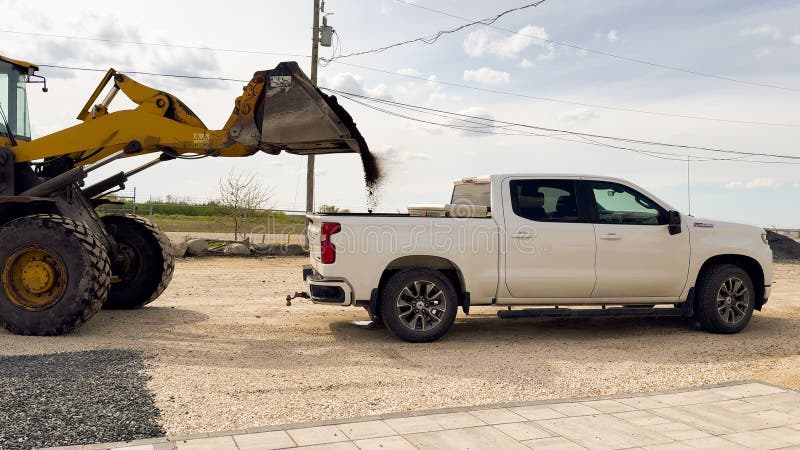 A Forklift Unloads Crushed Stone into a Vehicle. Stock Photo - Image of ...