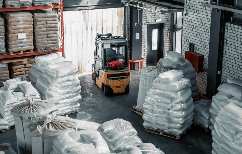 Forklift in Warehouse with Grain Bags for Export. Distribution and ...