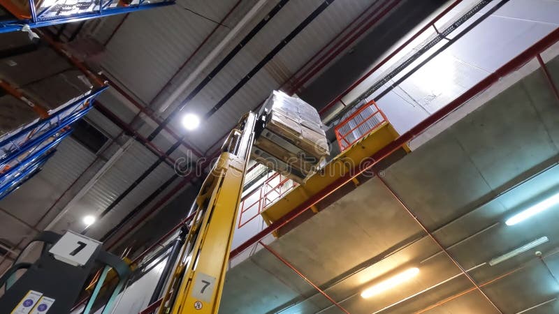 Forklift Work in a Warehouse. Modern Forklift Works in a Warehouse. Two ...