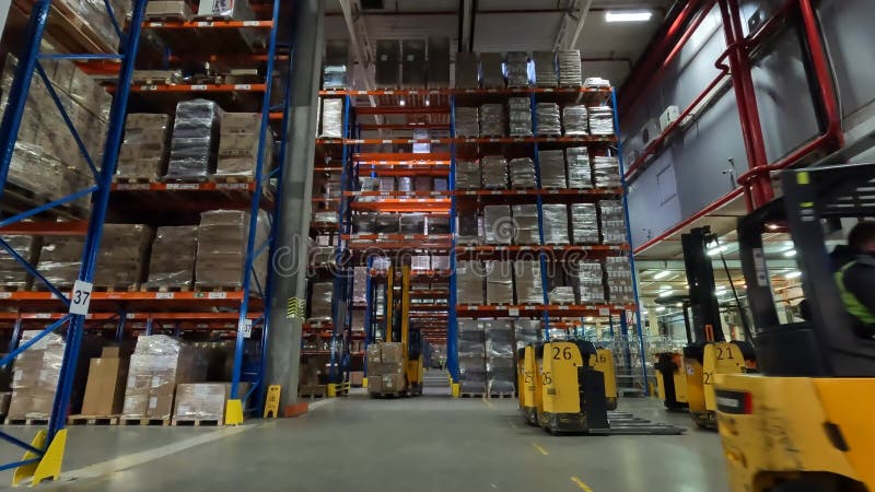 Active Work in the Warehouse. Modern Forklift Works in a Warehouse ...