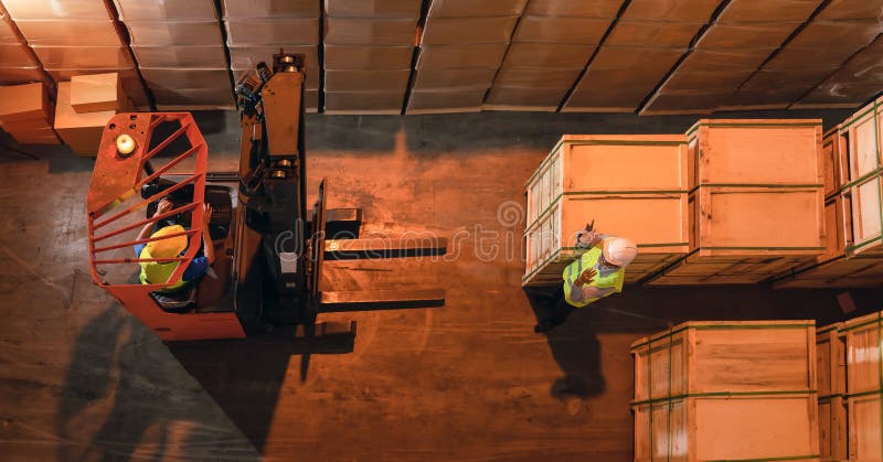 Forklift with Worker in Operation in Storage Warehouse To Move Pallets ...