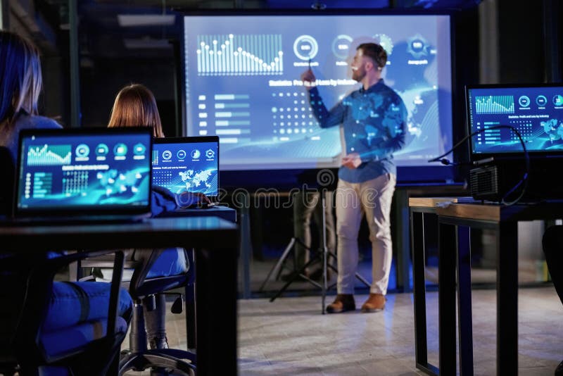 In Formal Clothes. Male Business Trainer is Against Projector with Data ...