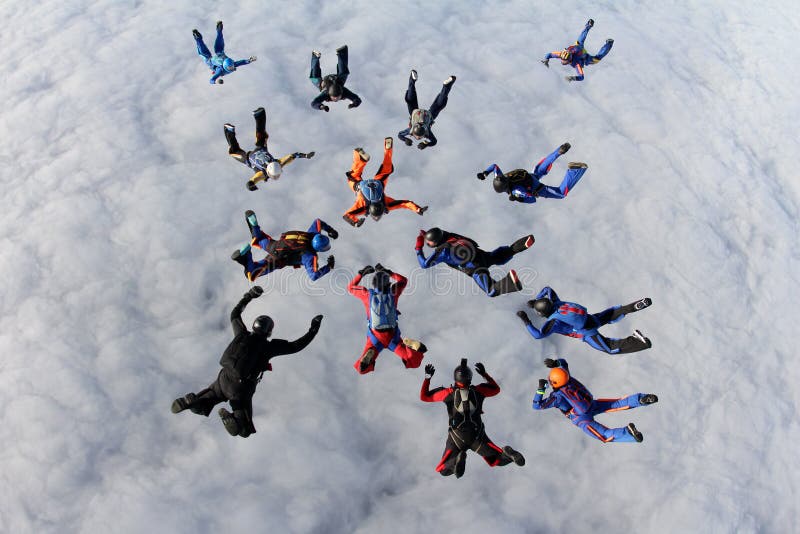 Formation Skydiving.a Big Group of Skydivers is in the Sky Above White ...