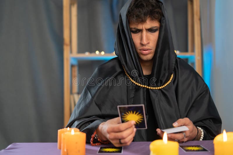 Fortune Teller Man Reading Tarot Cards on a Table with Candles. Stock ...