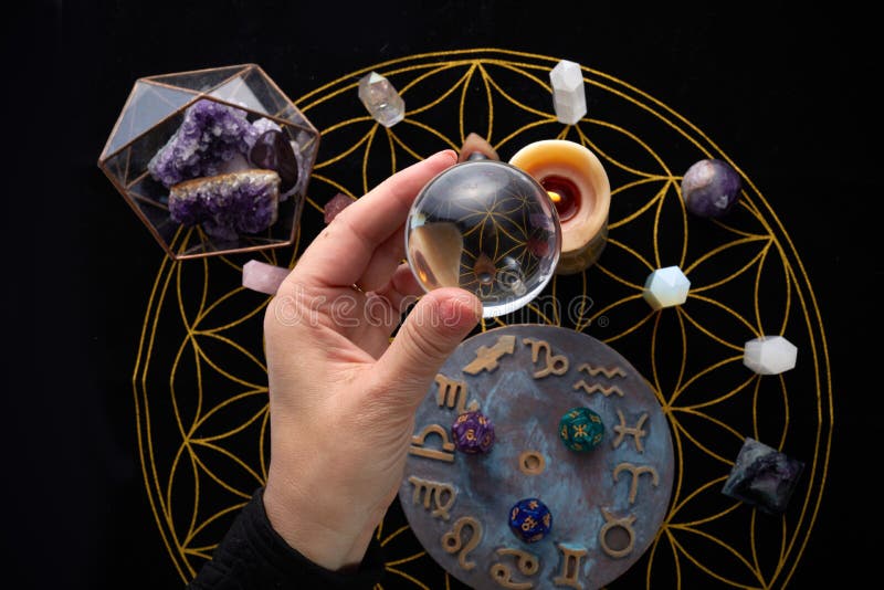 Fortune Telling Table with Esoteric Objects and Hand Holding Crystal ...