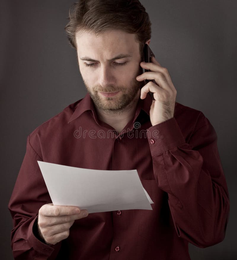 Office Worker Reading Paper Documents during Mobile Phone Conversation ...